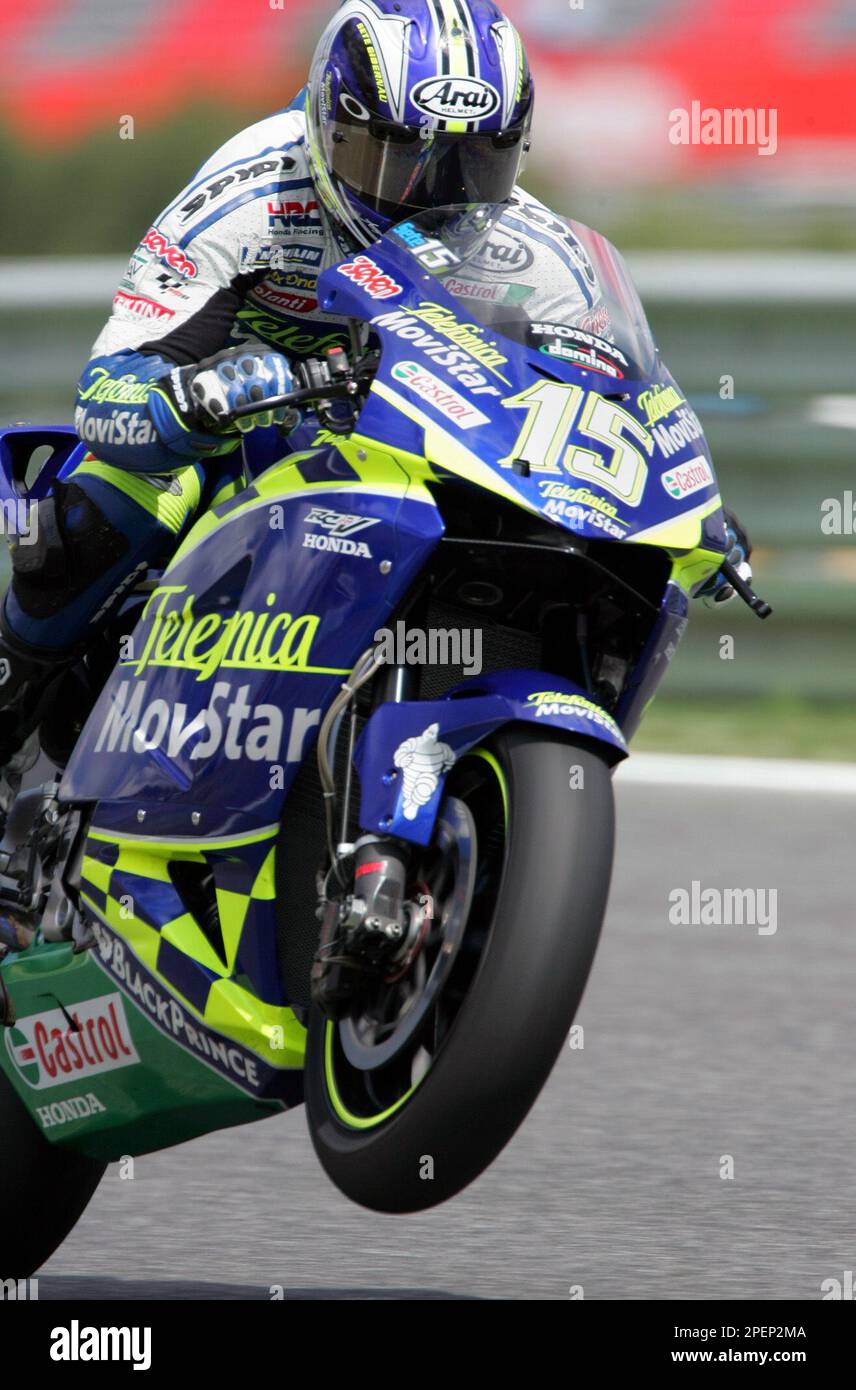 Spain's Sete Gibernau accelerates his Honda MotoGP out of a curve ...