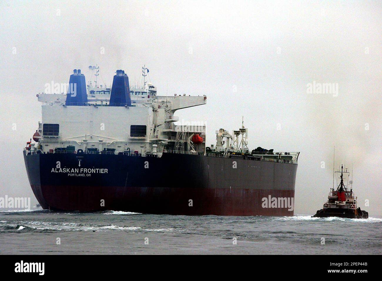 A tug escorts the Alaskan Frontier, BP Alaska's first of four new ...