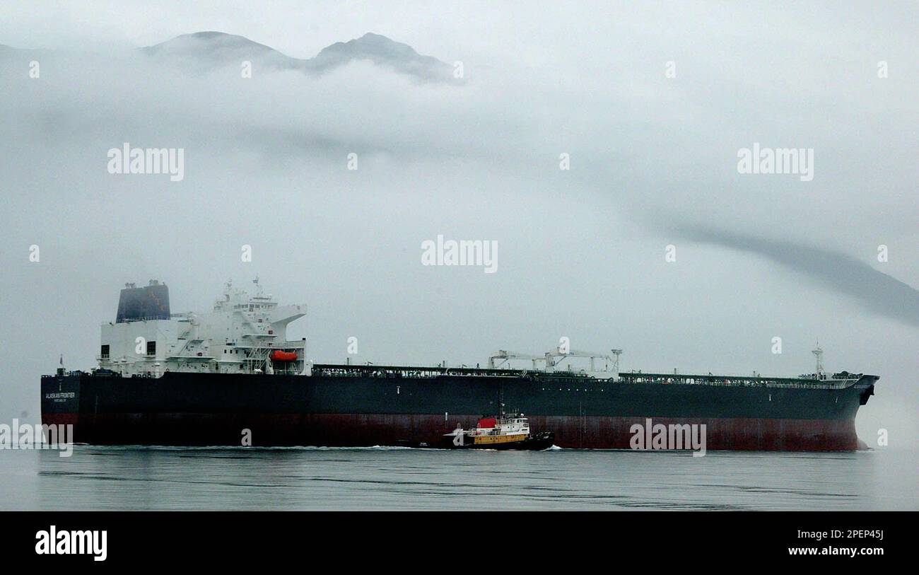 A tug boat escorts the Alaskan Frontier, BP Alaska's first of four new ...