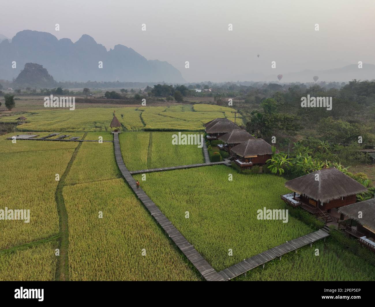 Aerial view of Vang Vieng and rice fields at sunset, Laos Stock Photo ...