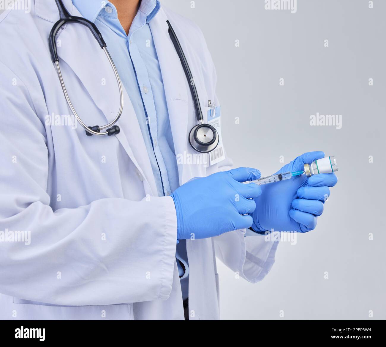 Injection, doctor hands and vaccine vial in studio for safety ...