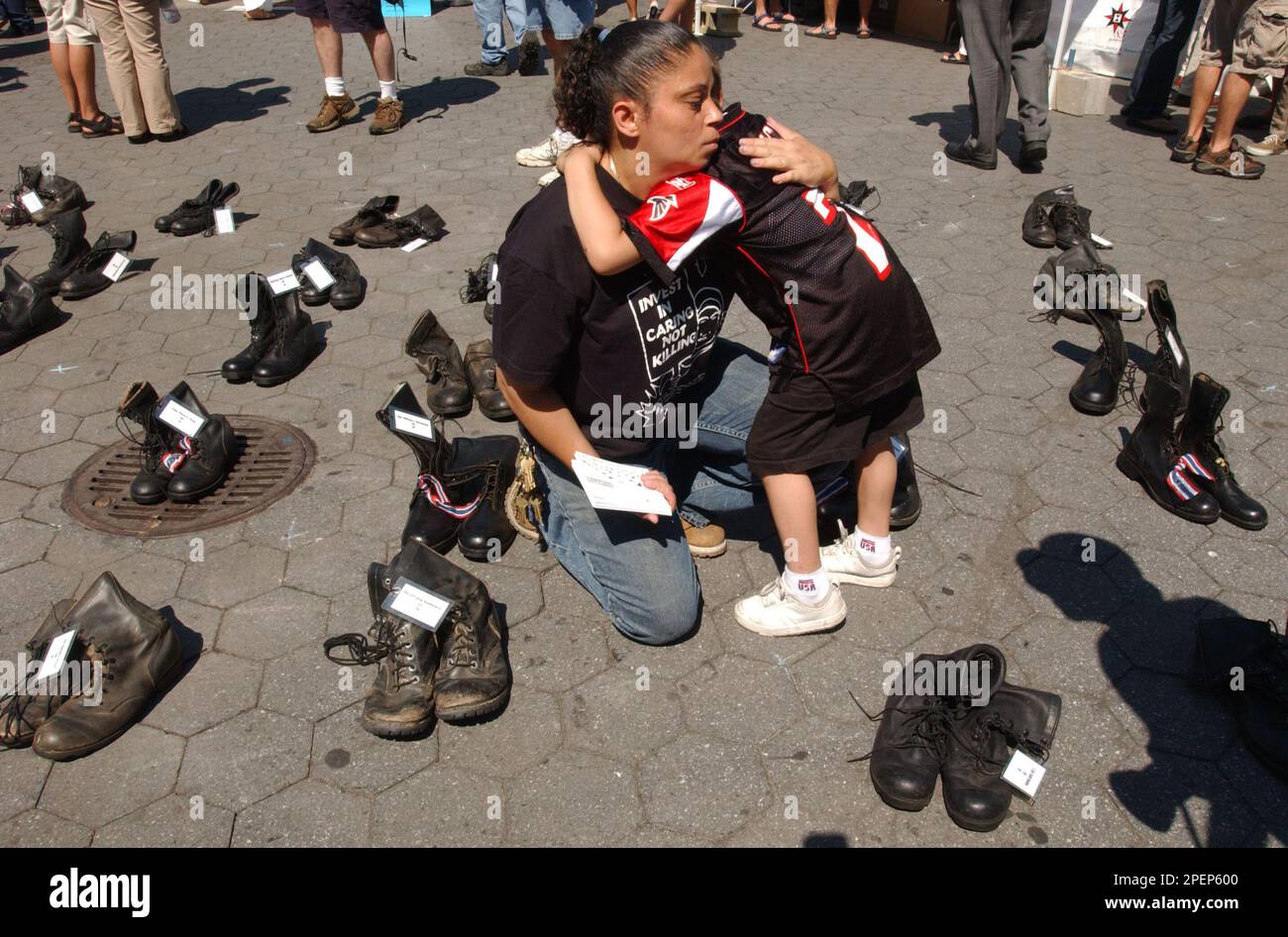Marian Perez, of N.Y., embraces his grandson Michael Tirado, 6, at the ...