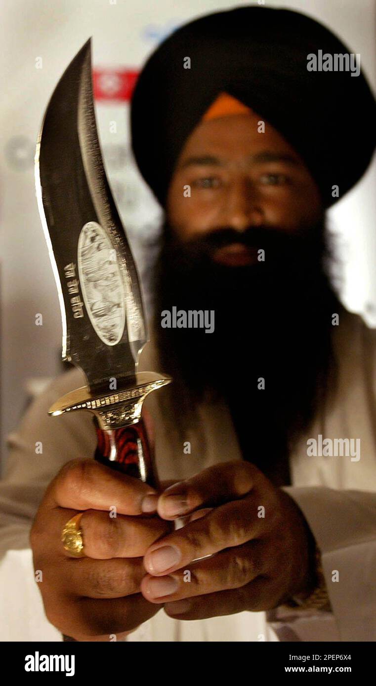 A Sikh priest displays a Kirpan, ceremonial Sikh sword, at the launch ...