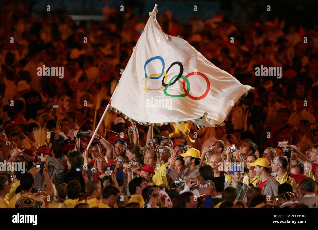 Athletes wave the Olympic flag during the closing ceremony of the 2004 ...