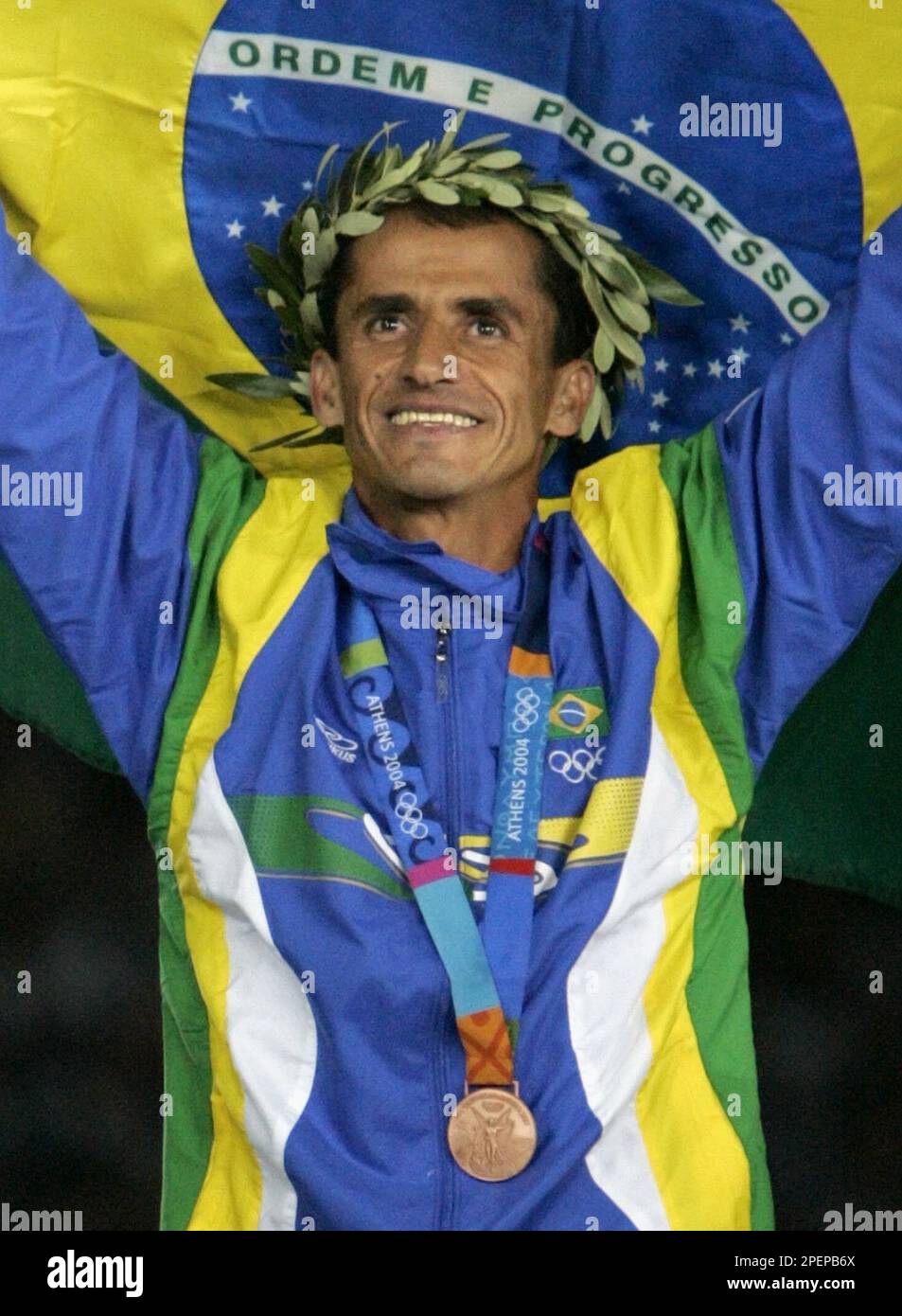 Vanderlei de Lima of Brazil waves on the podium after being awarded the ...