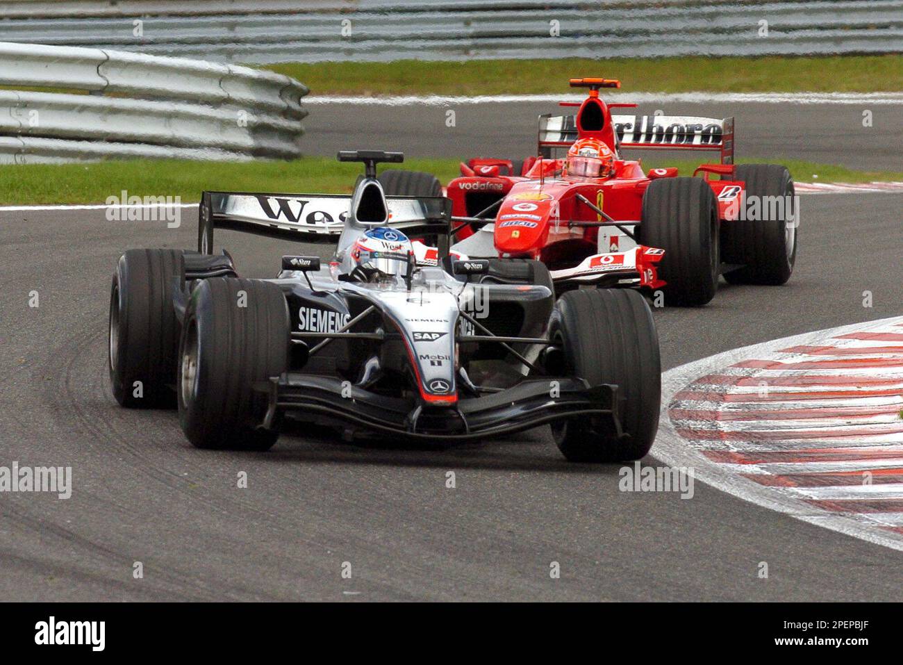 Finnish McLaren driver Kimi Raikkonen, left, steers his car into a ...