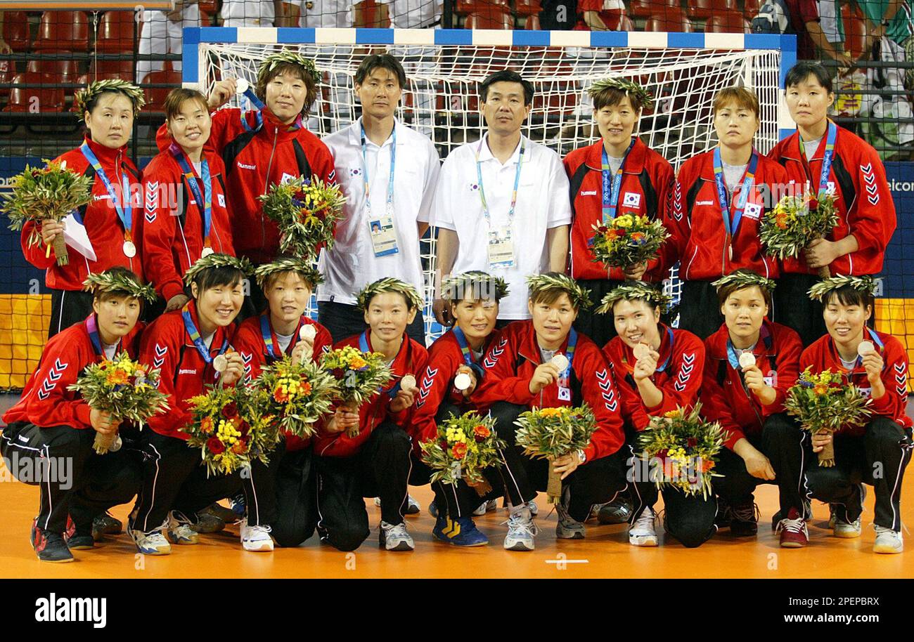 The Korean team pose with their silver medals after the women's ...