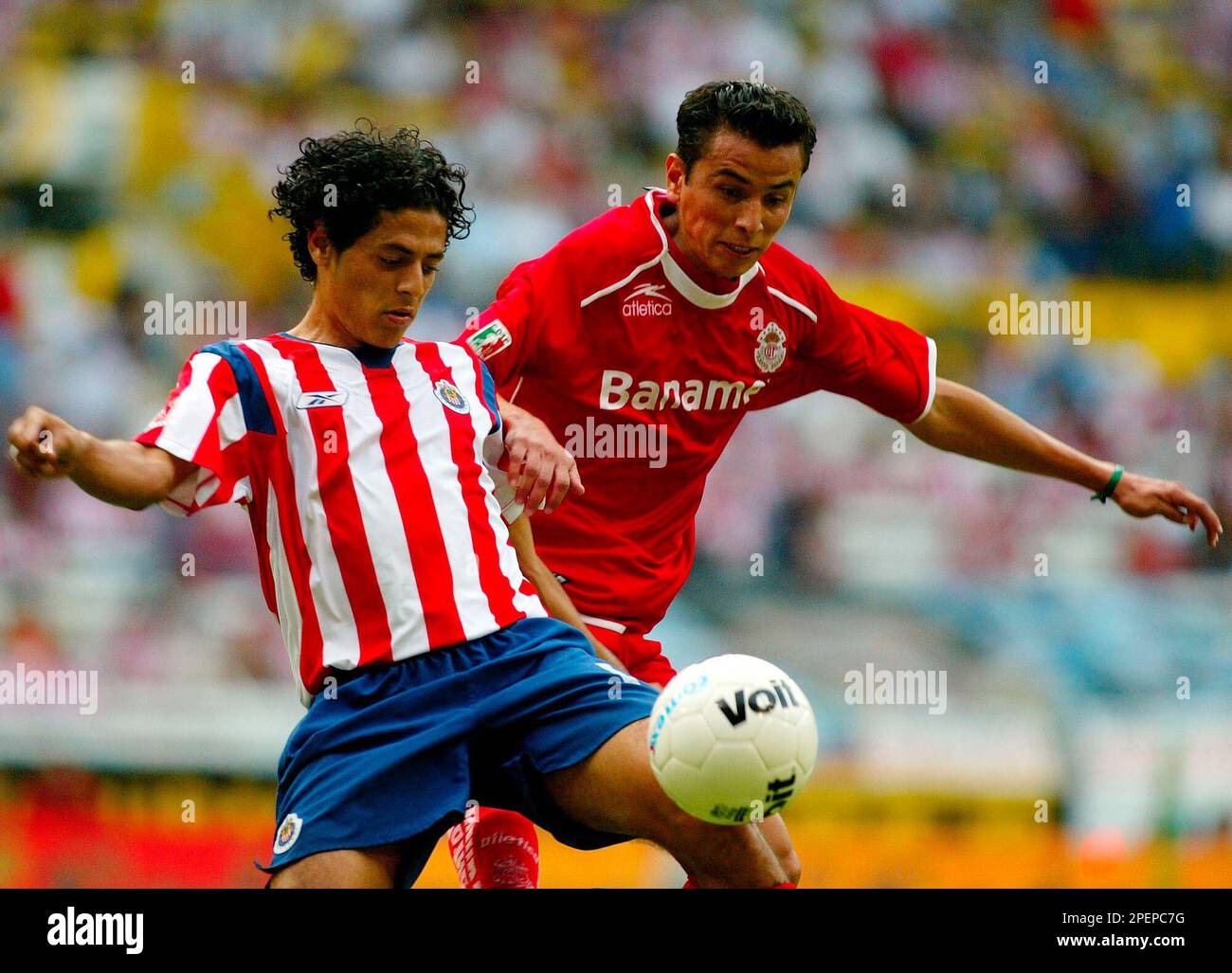 Chivas player Alejandro Vela, left, fight for the ball against Tolucas ...
