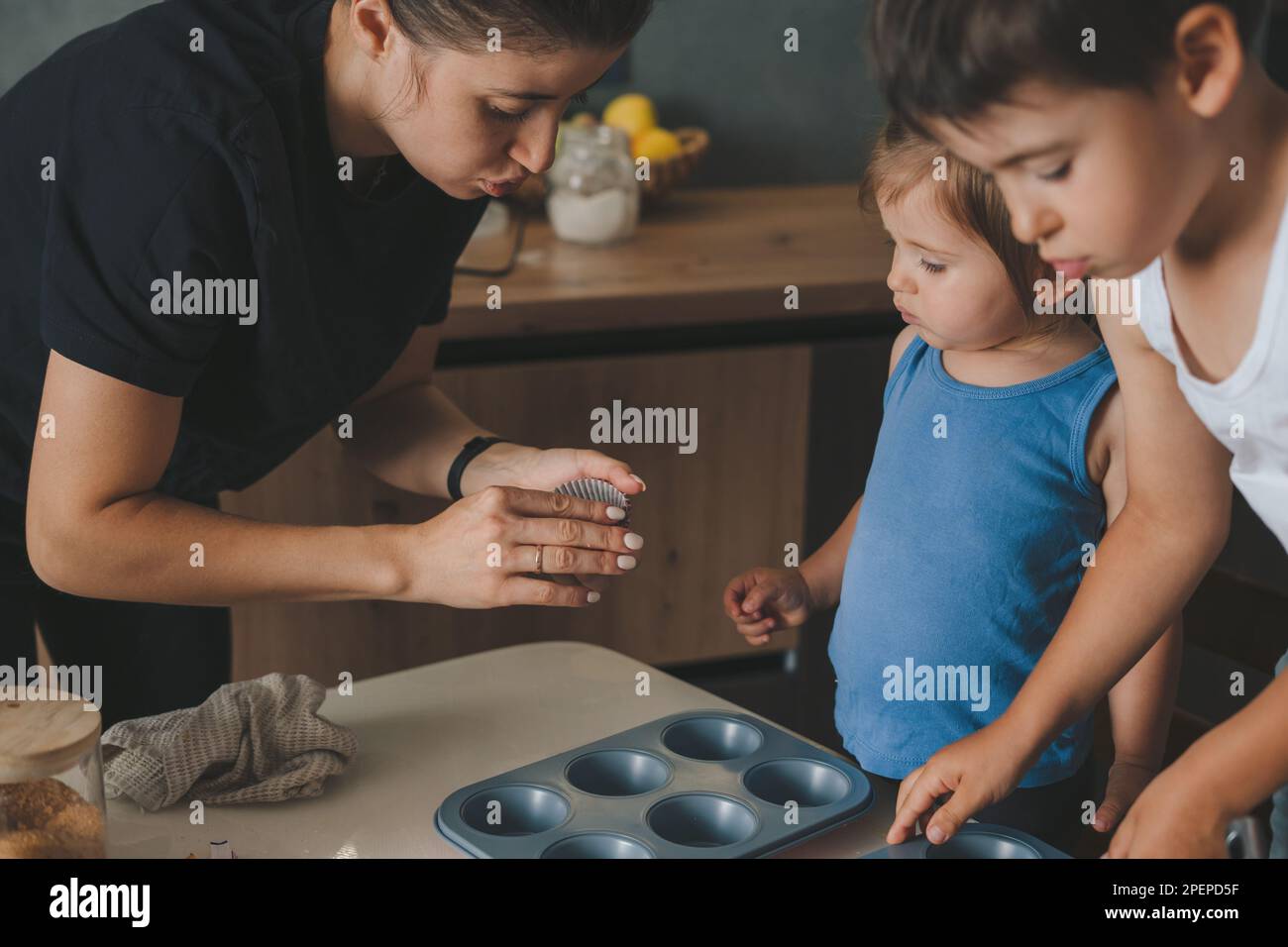 Portrait happy mother teaching cooking their kids doing bakery, make ...