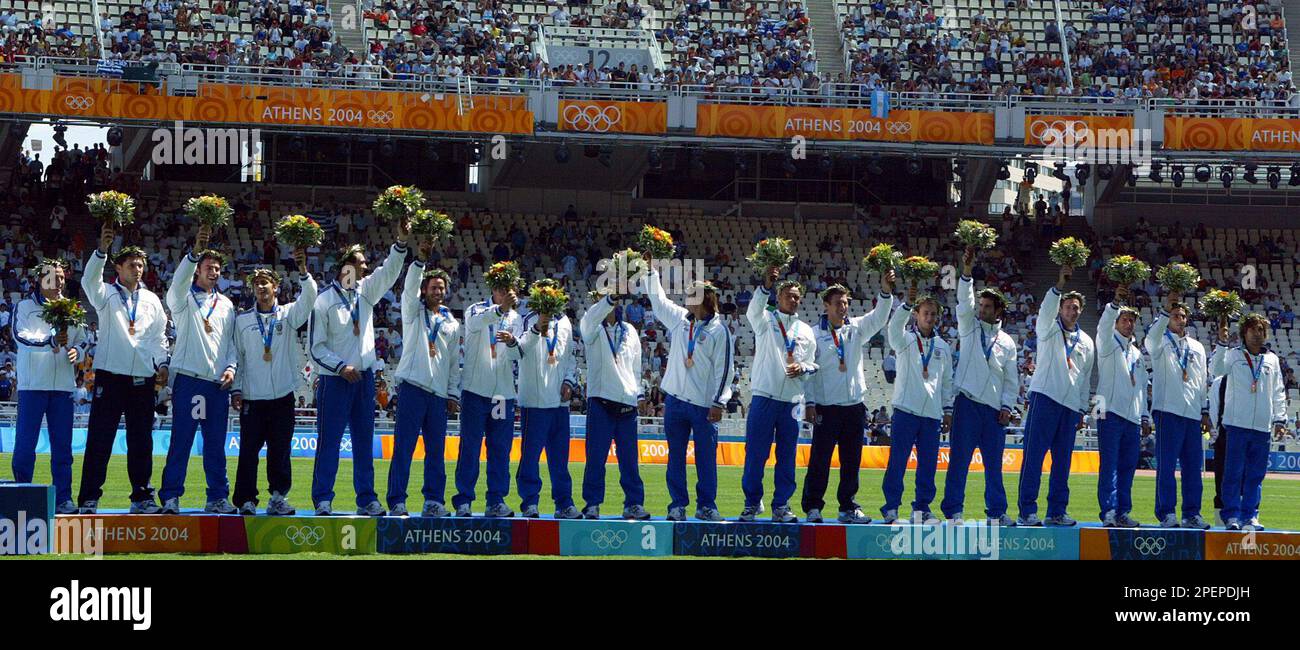 The Italian soccer squad pose with their bronze medals following a ...
