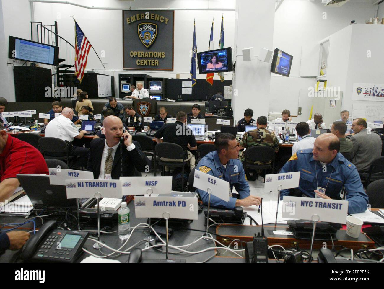 Members from a variety of military and police units work the phones in ...