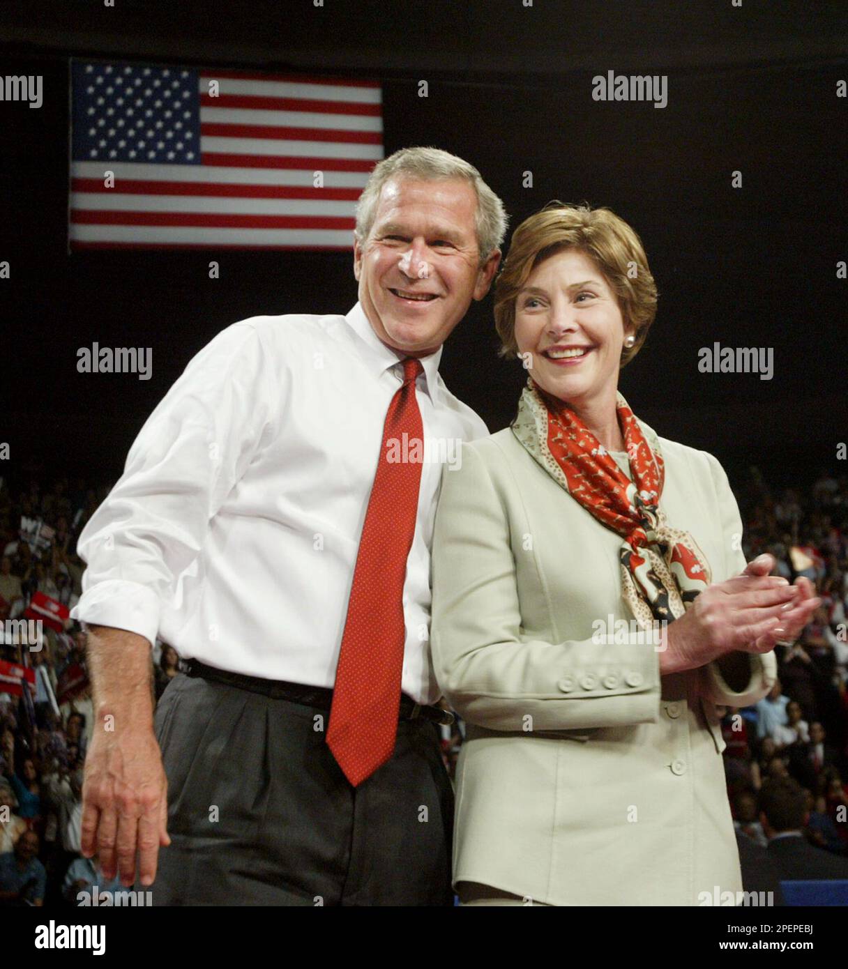 President Bush , left, is joined on stage by his wife first lady Laura ...