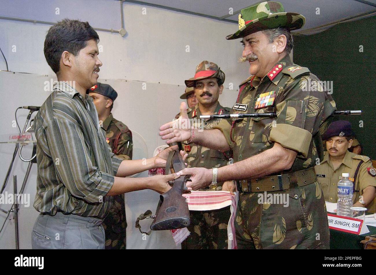 A United Liberation Front of Assam (ULFA) militant surrenders his arms ...