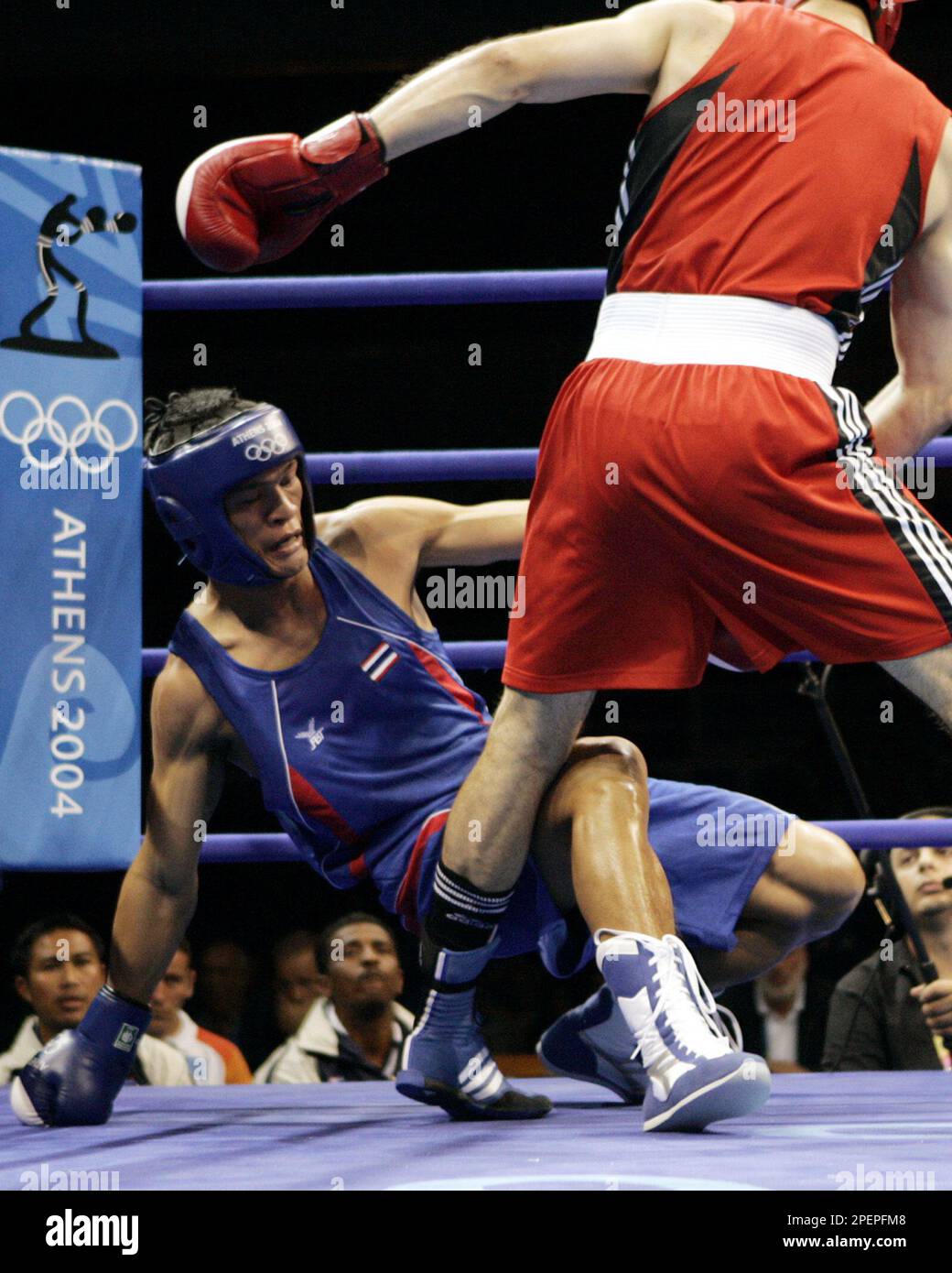 Thailand's Prasathinphimai Suriya tries to stand up on the canvas after ...