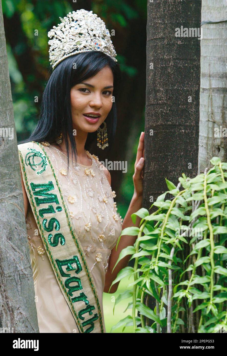 Reigning Miss Earth Dania Prince from Honduras peers through palm trees ...