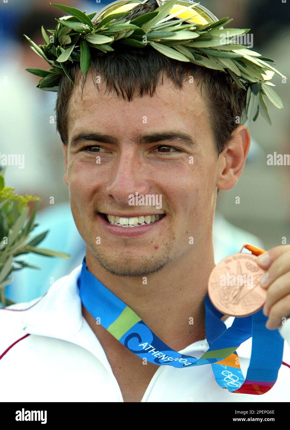 Adam Van Koeverden of Canada displays the bronze medal he won in the ...