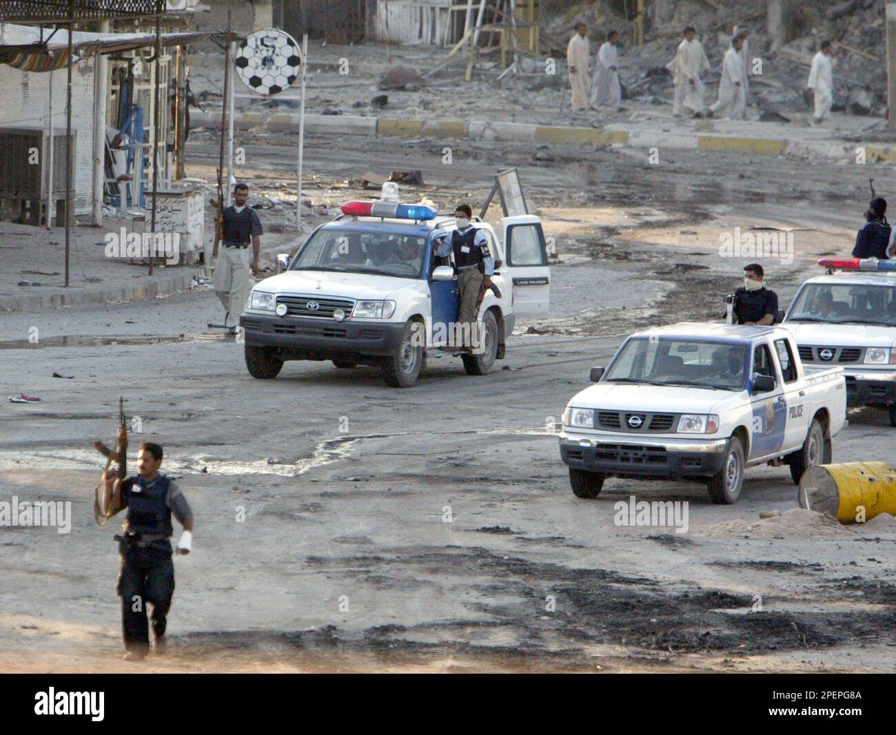 Iraqi Police patrol central Najaf, Iraq, early Friday, Aug. 27, 2004 ...