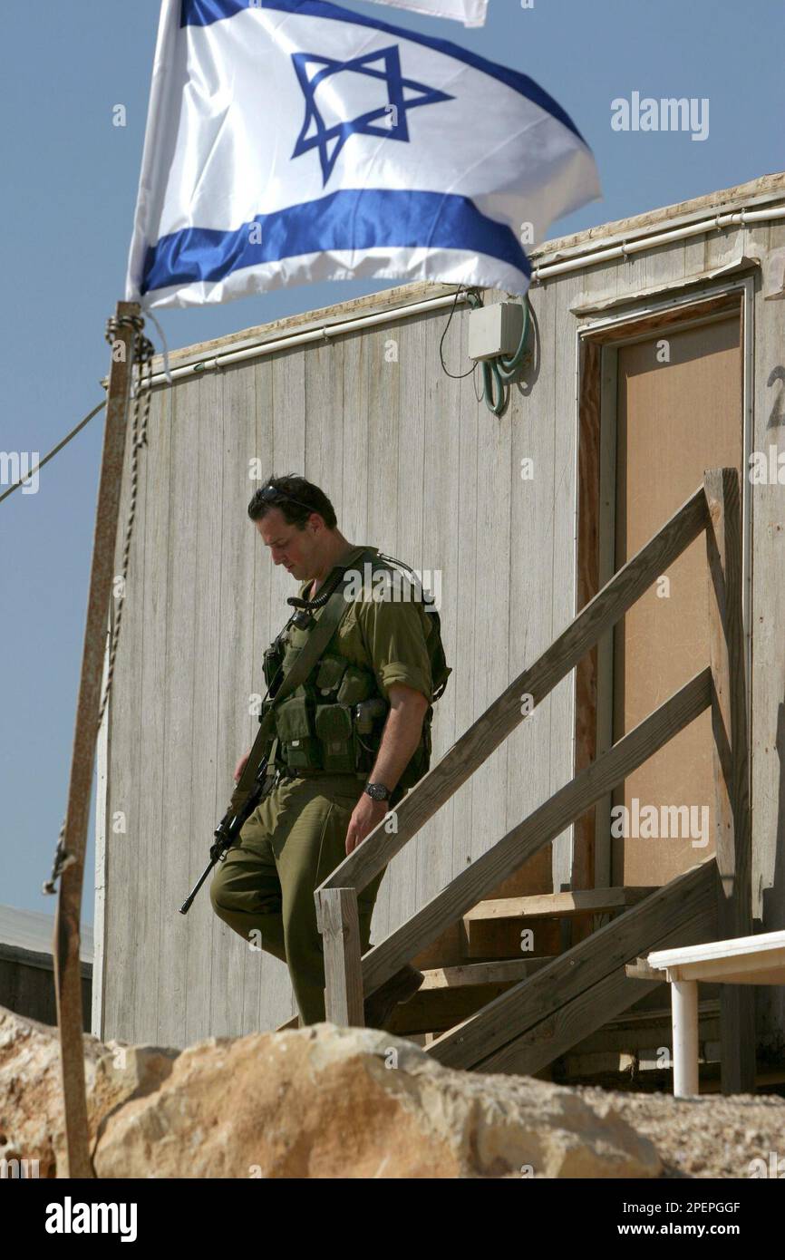 Eran Kurtzer, 33, a major in the Israeli reserves walks down a stairs of a military post near ...