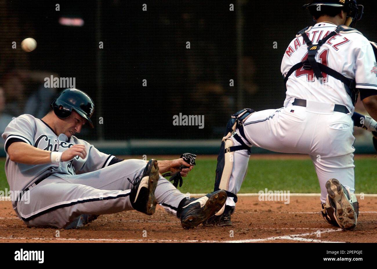 Chicago White Sox's Ross Gload, left, scores as Cleveland Indians ...