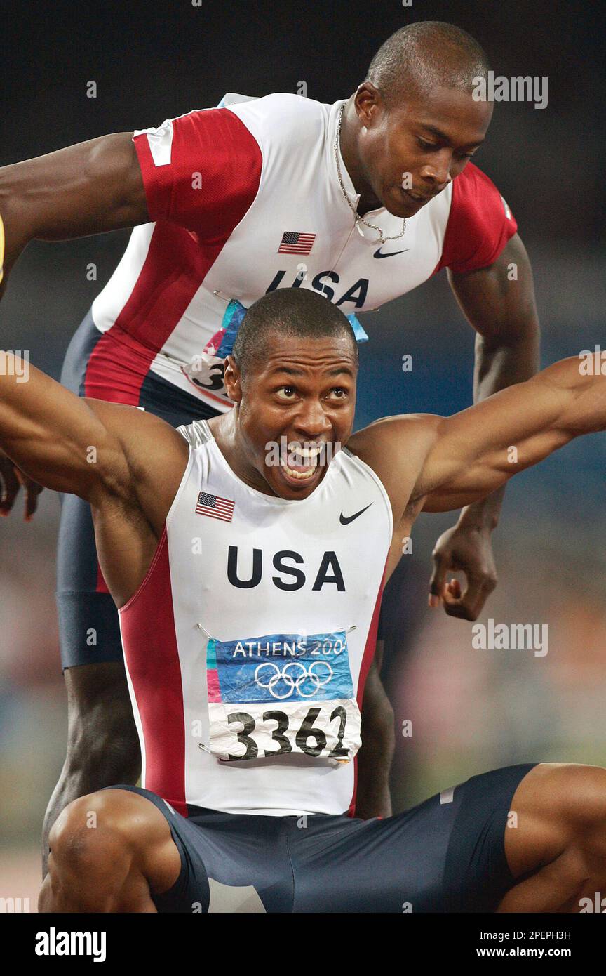 Gold medalist Shawn Crawford, top, of the U.S. and teammate Bernard ...