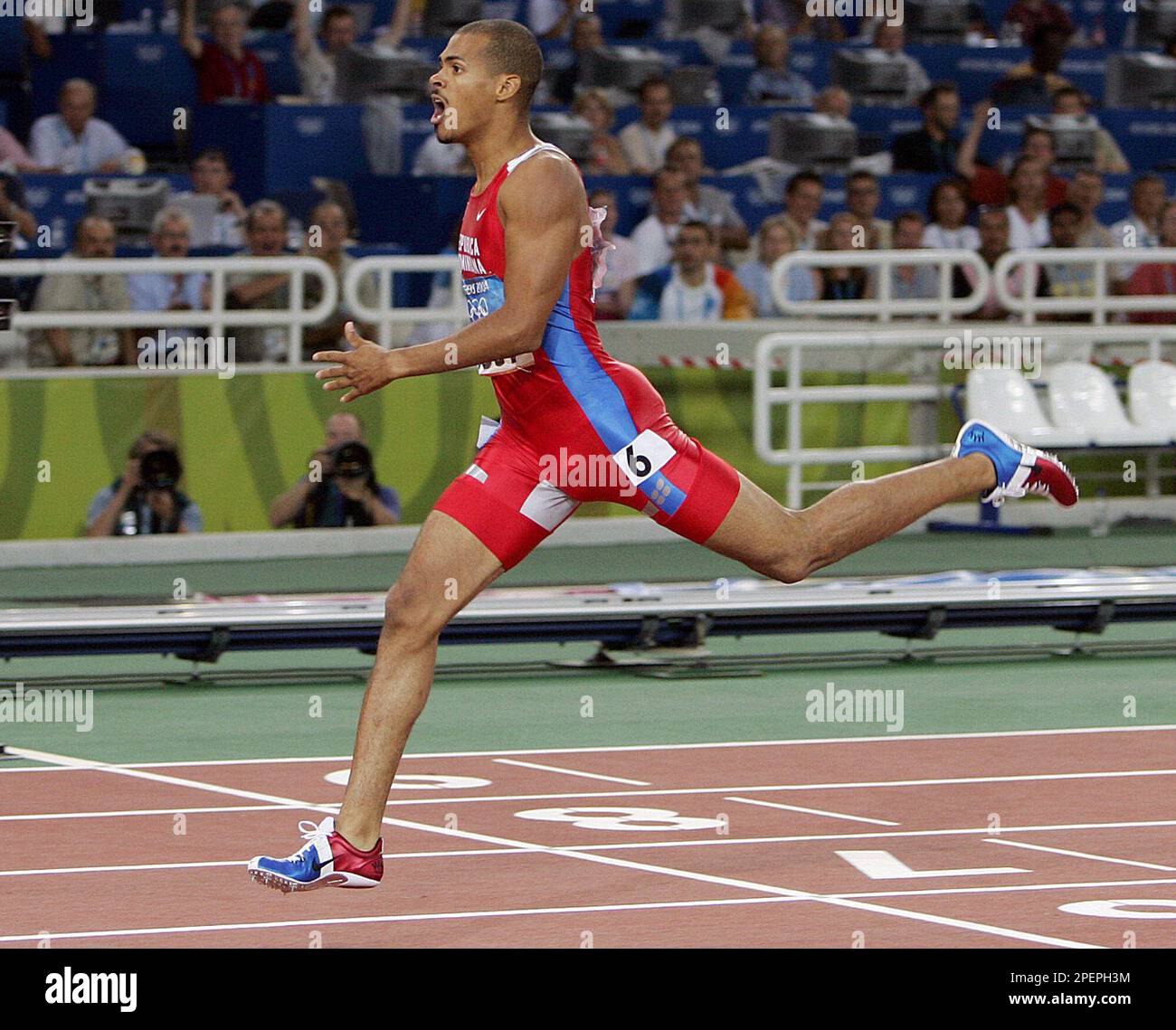 Felix Sanchez, of the Domincan Republic, reacts as he crosses the ...