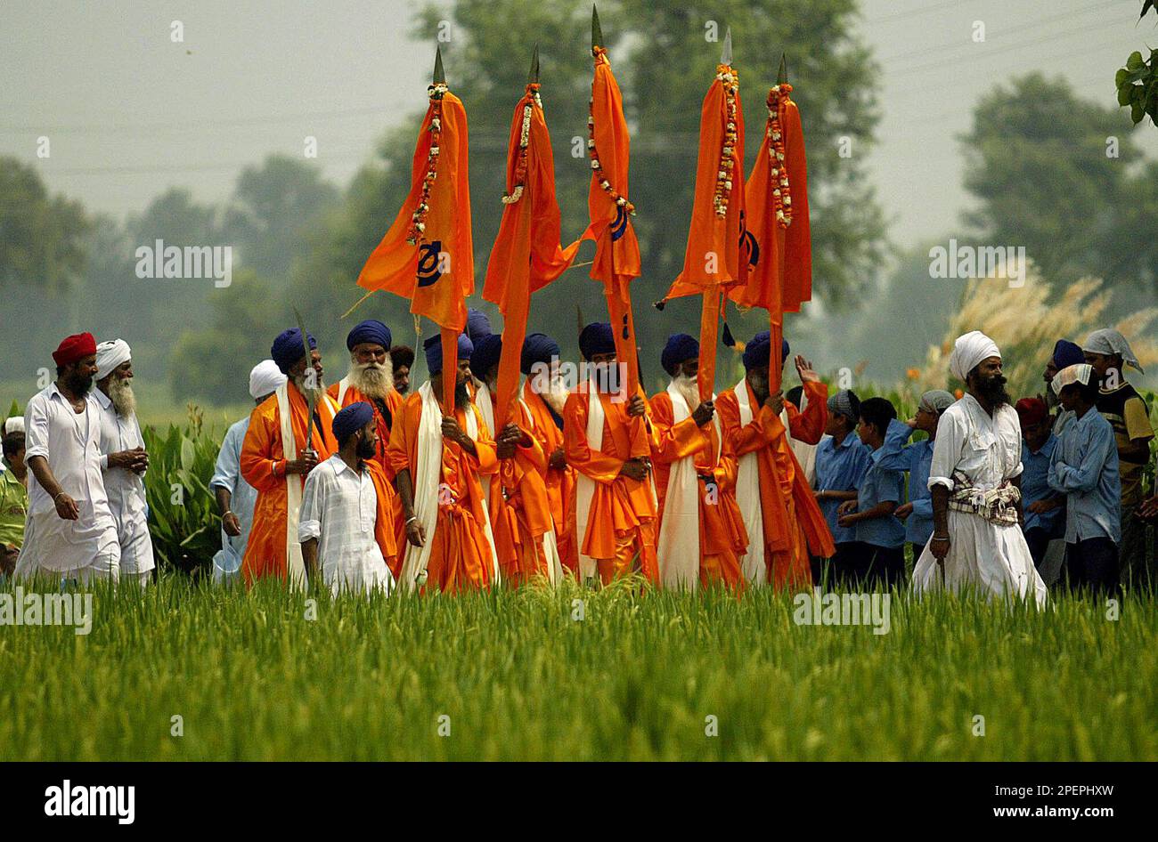 Five baptized Sikhs lead a religious procession during celebrations for ...