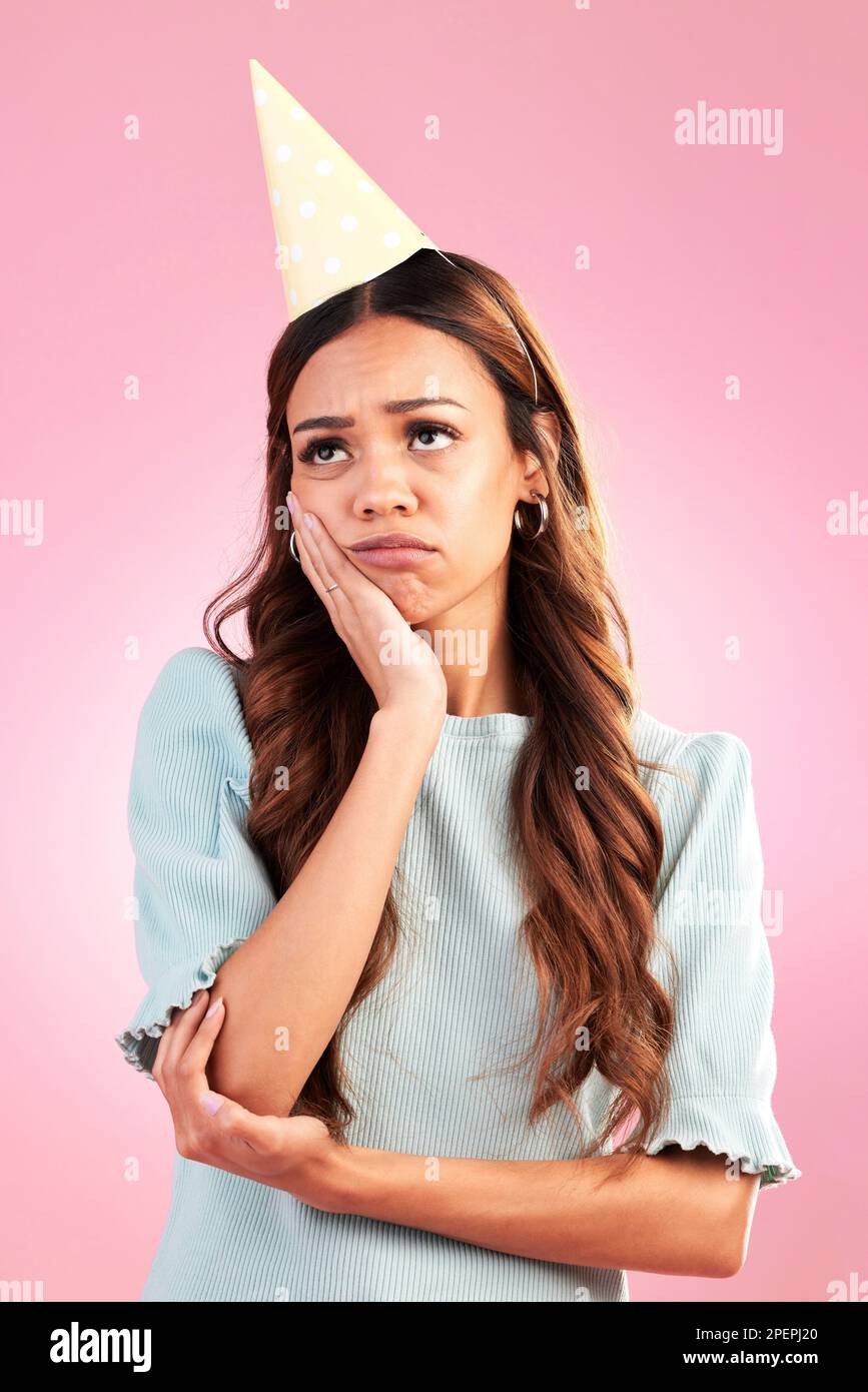 Sad, birthday and hat with woman in studio for party celebration, upset ...