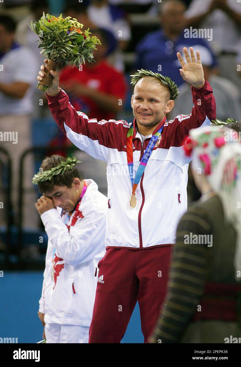 Istvan Majoros, of Hungary, waves, after receiving the gold medal he ...