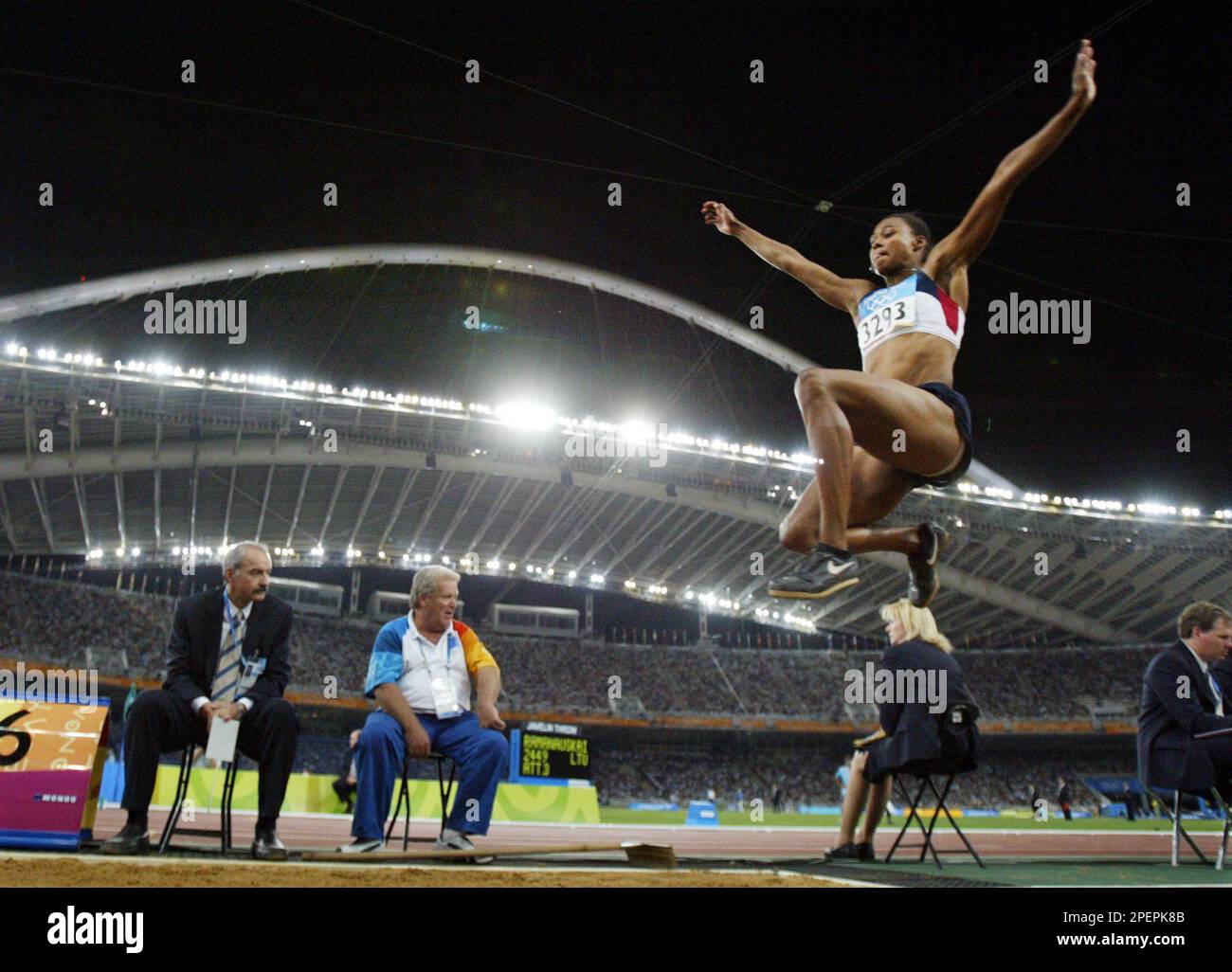 Marion Jones, of the United States, jumps in a qualifying heat of the ...