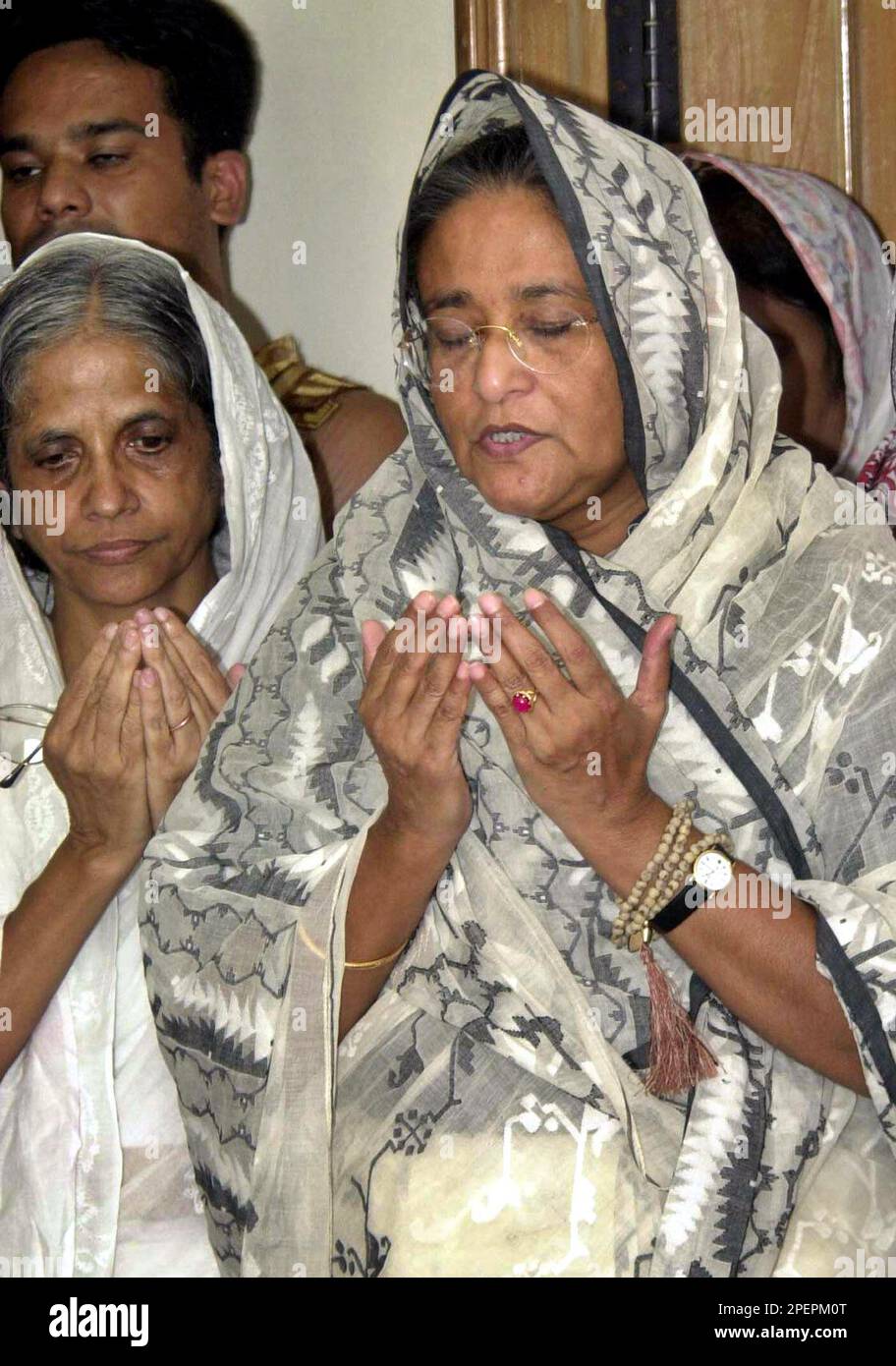 Bangladesh opposition leader Sheikh Hasina, right, prays at the ...