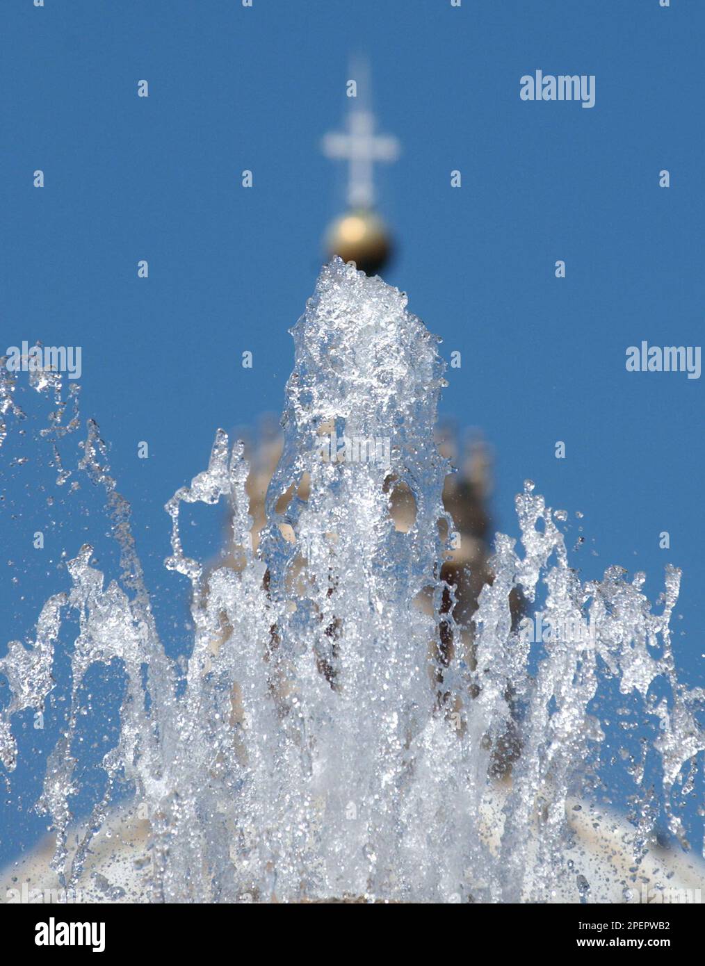 Jets of water from a fountain under St. Peter's basilica, in background ...