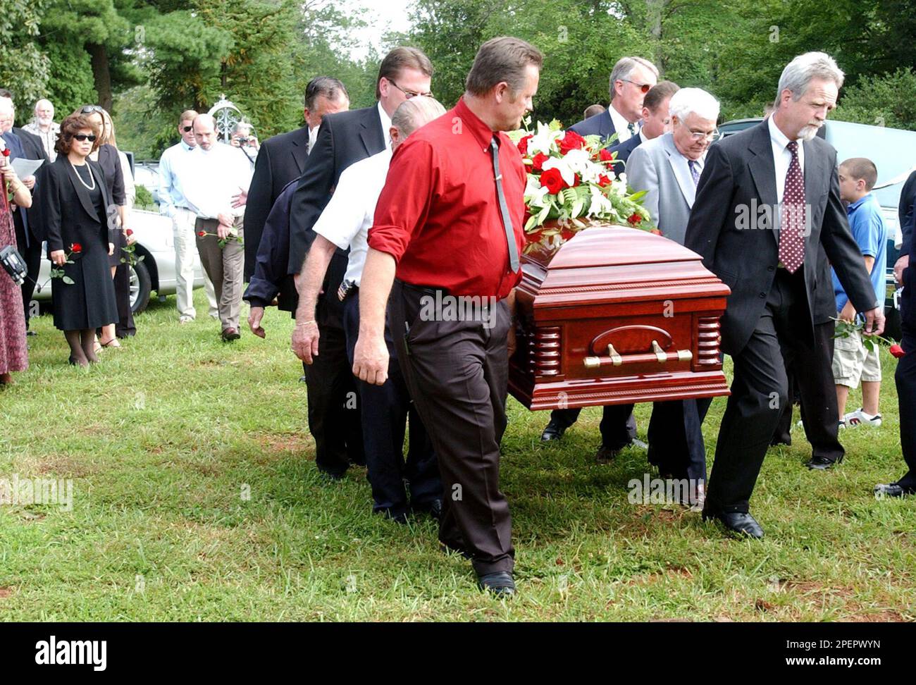 Pallbears carry the casket of Bluegrass legend Charlie Waller at ...