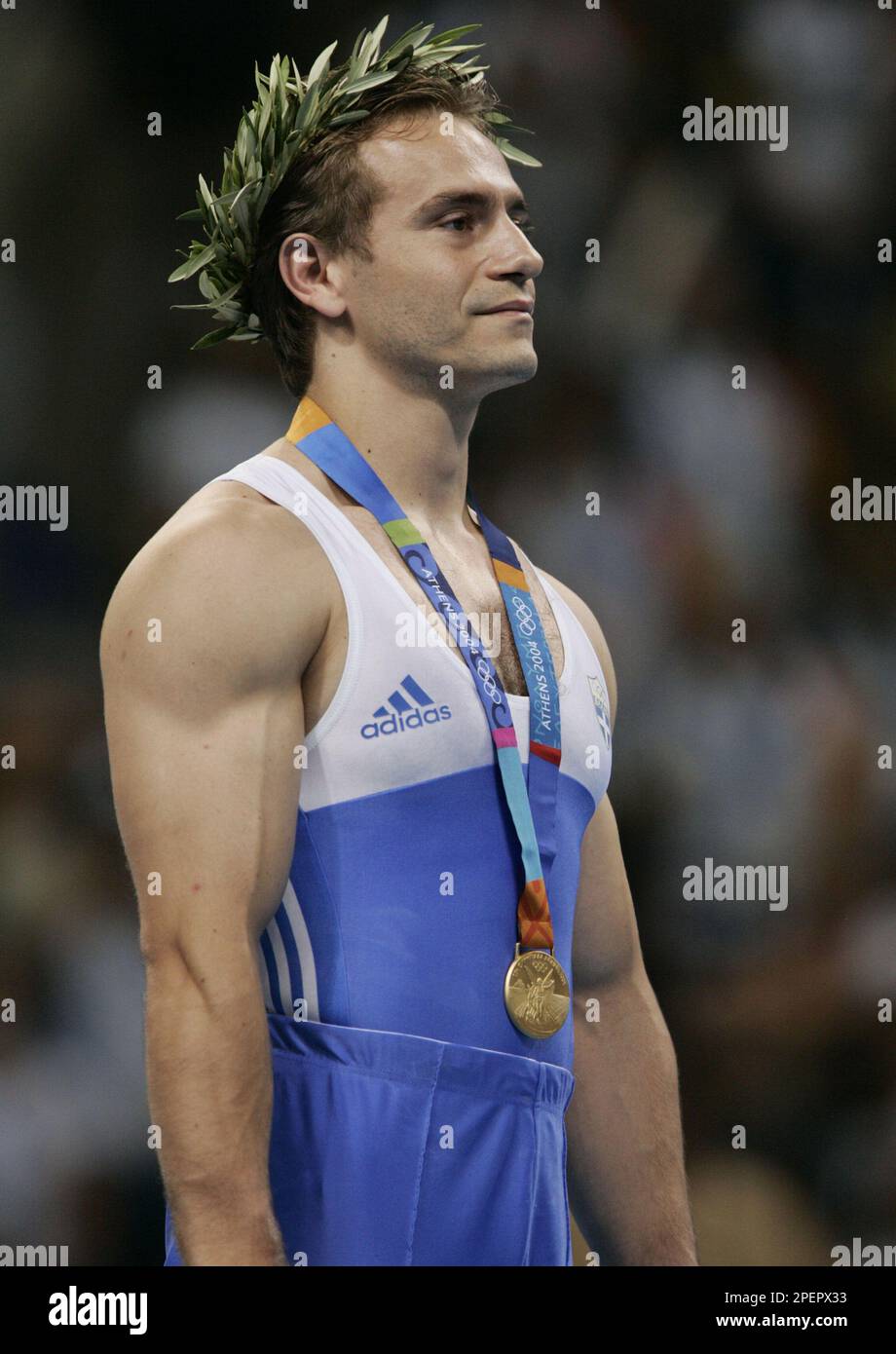 Greek's Dimosthenis Tampakos stands with his gold medal for the rings ...