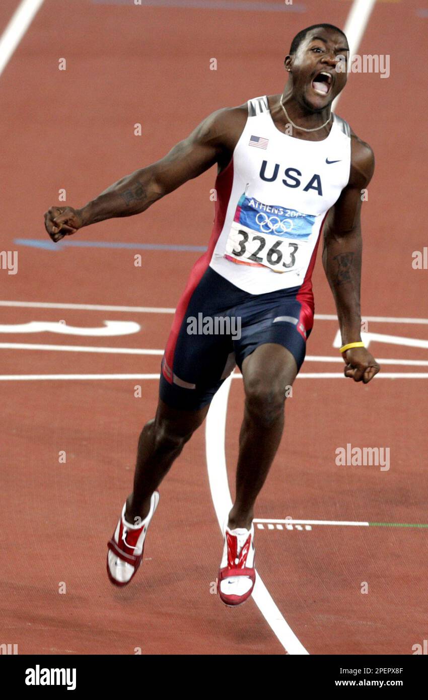 Jason Gatlin, of the United States, reacts after winning the gold medal ...