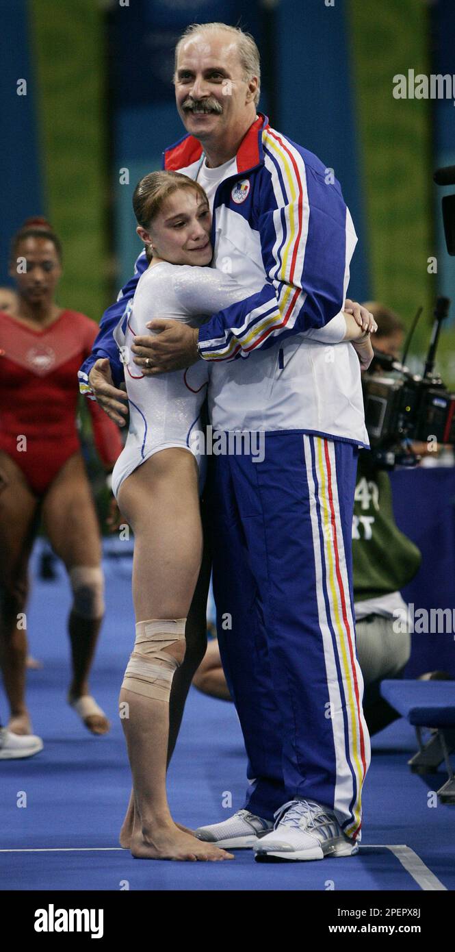 Romania's Monica Rosu, left, is embraced by coach Octavian Belu after ...
