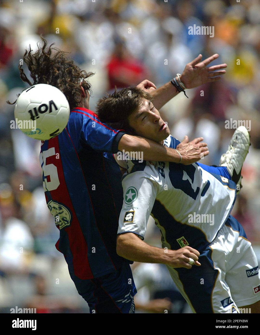 Puma's soccer player Diego Alonso, right, heads the ball as Atlante's ...