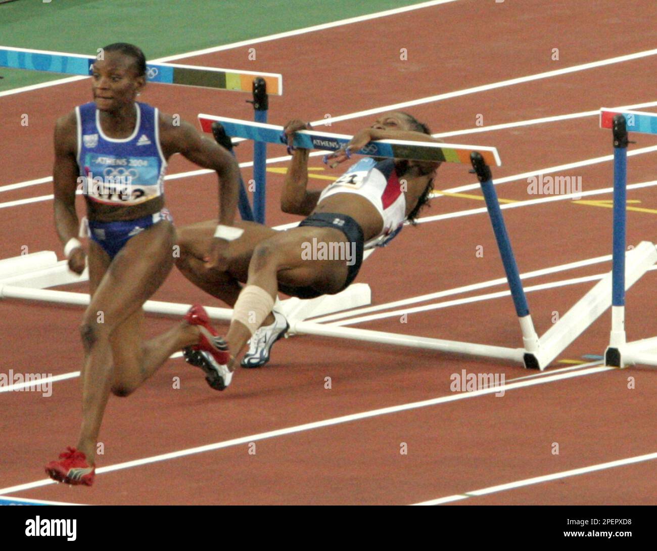 Gail Devers, of the United States, slides under the first hurdle in a ...