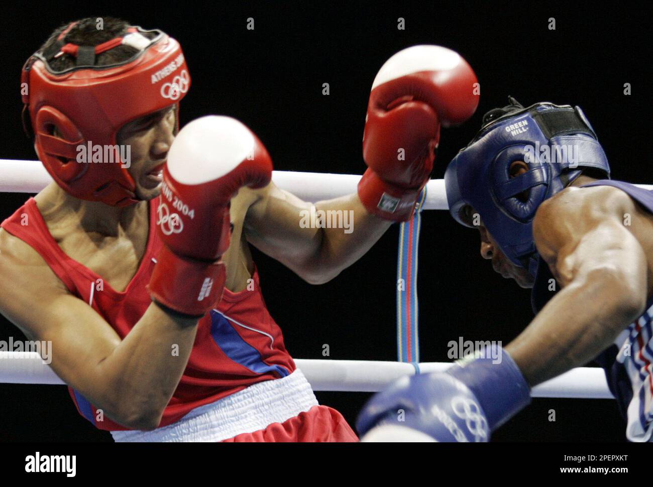 Thailand's Boonjumnong Manus, left, and France's Willy Blain fight during the light welterweight ...