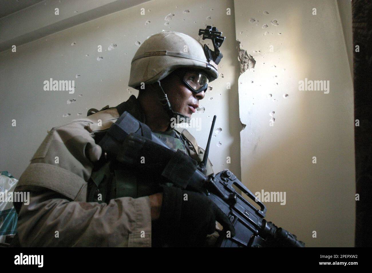 A U.S. Army soldier searches a building after moving forward into a ...