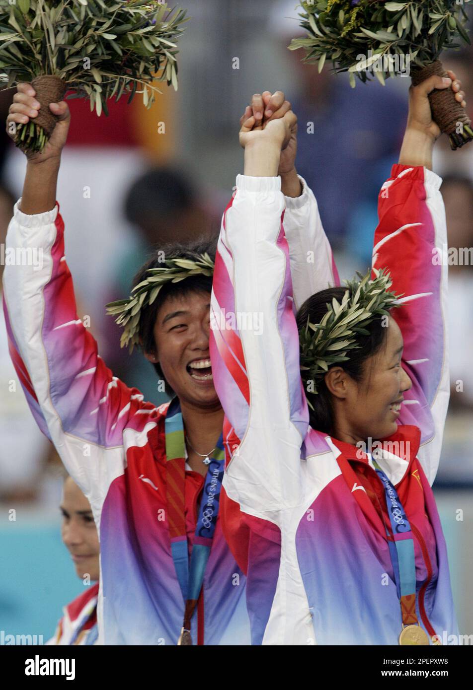 China's Li Ting, left, and Sun Tian Tian celebrate their gold medal win ...