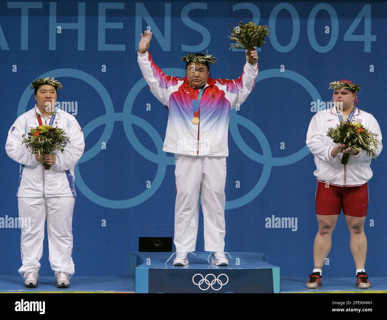 Gold medalist Tang Gonghong of China, center, waves to the crowdas she ...