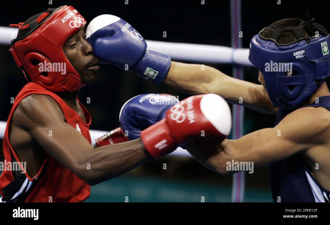 Uzbekistan's Tulashboy Doniyorov, right, reaches out his right on ...