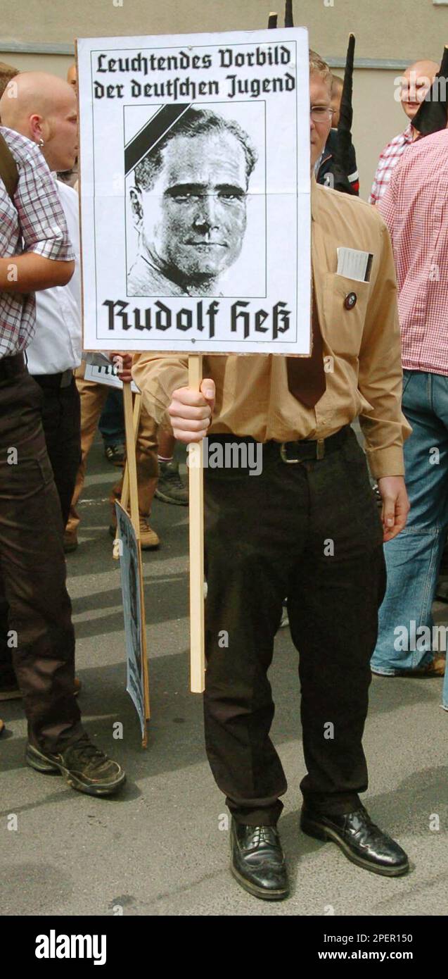 Ein Teilnehmer traegt ein Plakat vor Beginn eines Gedenkmarsches fuer ...