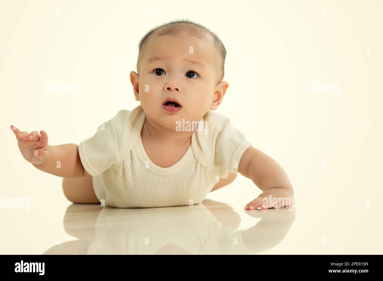 Lovely baby play prone on the floor Stock Photo - Alamy