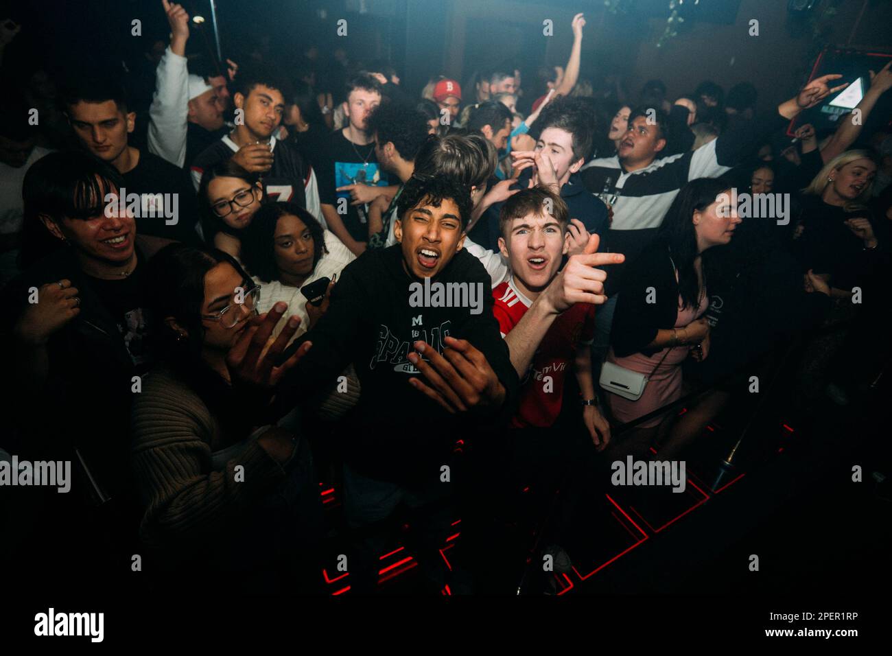 Let's rave! A group of young adults dance and enjoy the electric ...