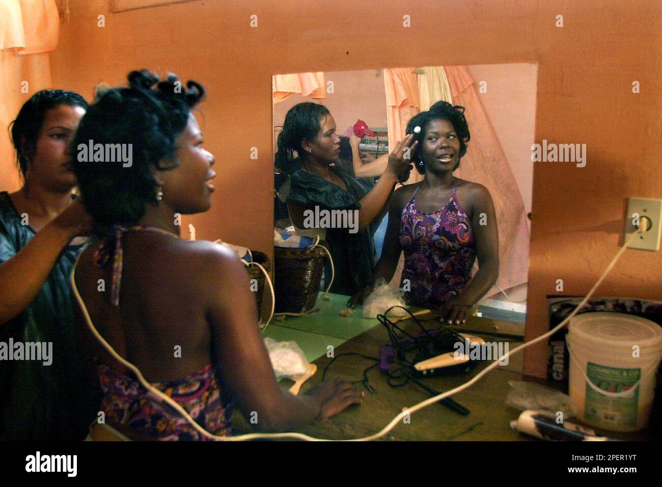 Brazilian inmates put make up on their faces before participating in a ...