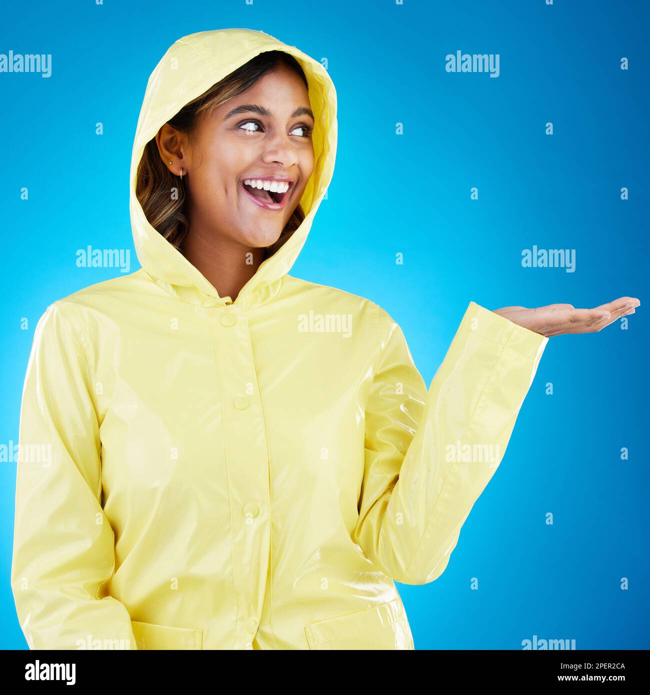 Hand, rain and happy woman in studio excited for weather, drop or storm ...