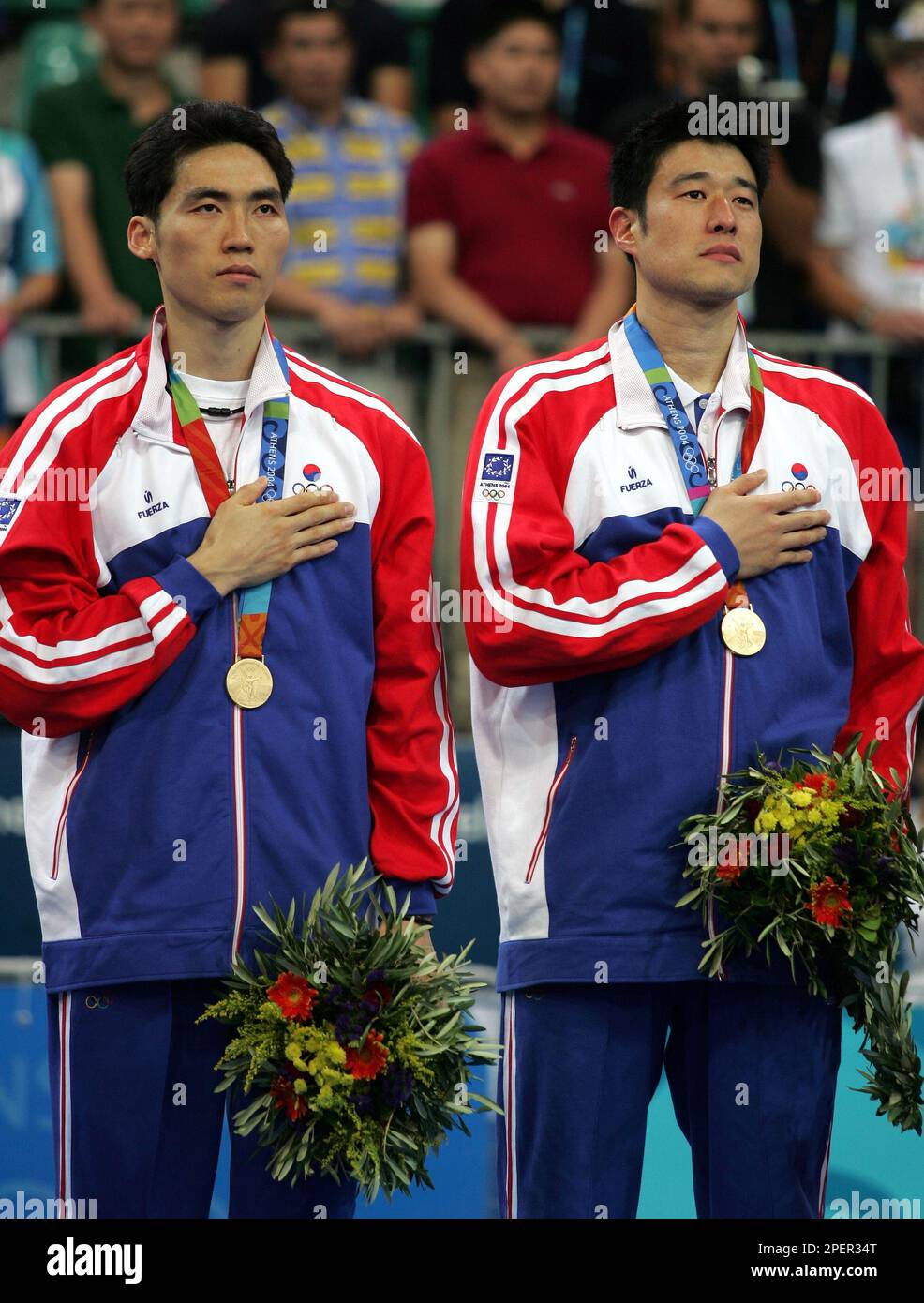 Kim Dong Moon, left, and his teammate Ha Tae Kwong from Korea listen to ...