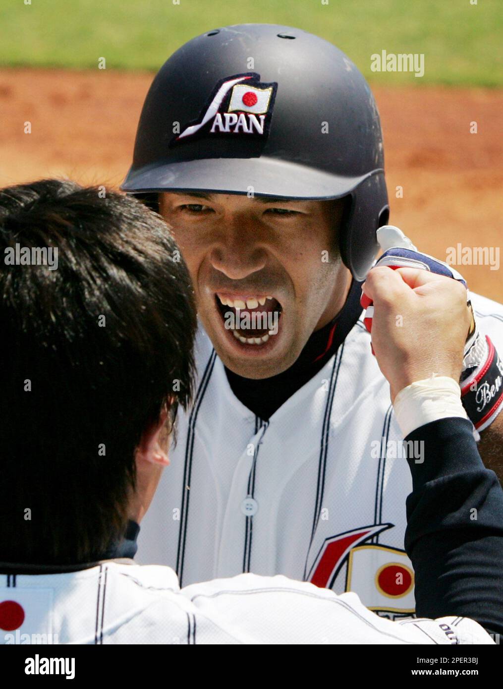 Japan's Kazuhiro Wada celebrates with teammates after hitting a solo ...
