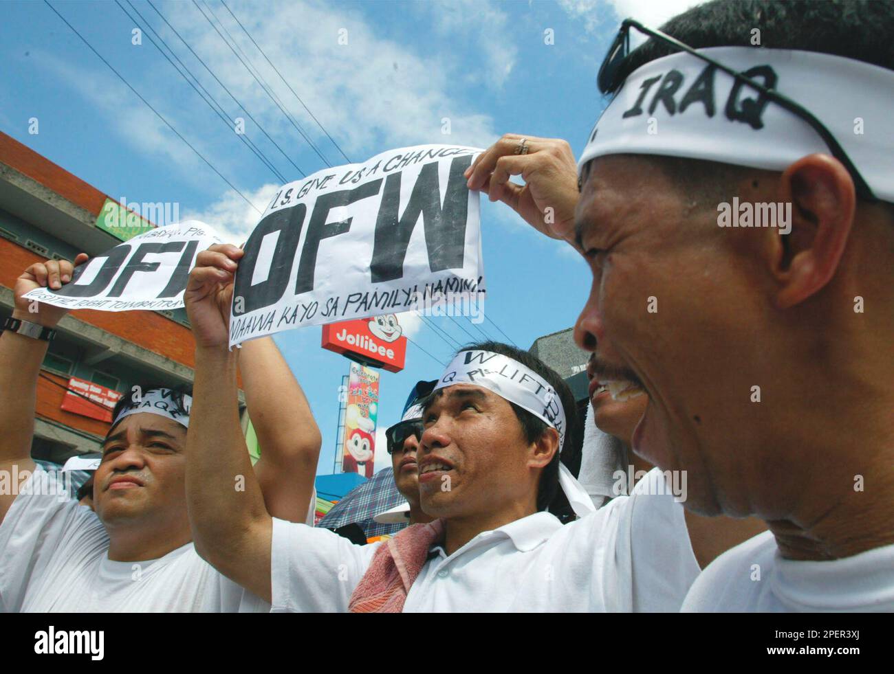 Filipino OFWs (Overseas Filipino Workers) shout slogans during a rally ...